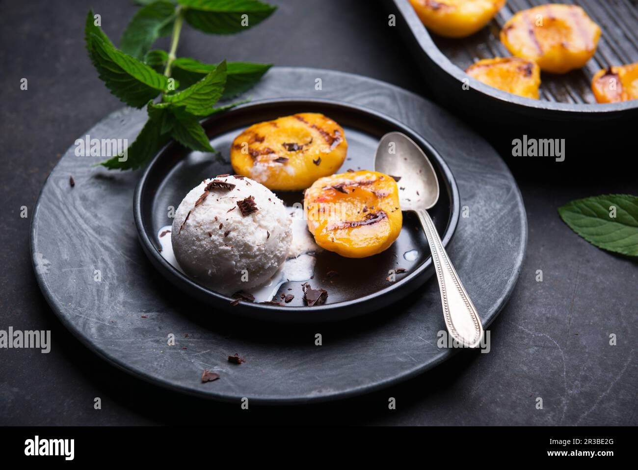 Vegan tonka bean ice cream with grilled peaches Stock Photo - Alamy