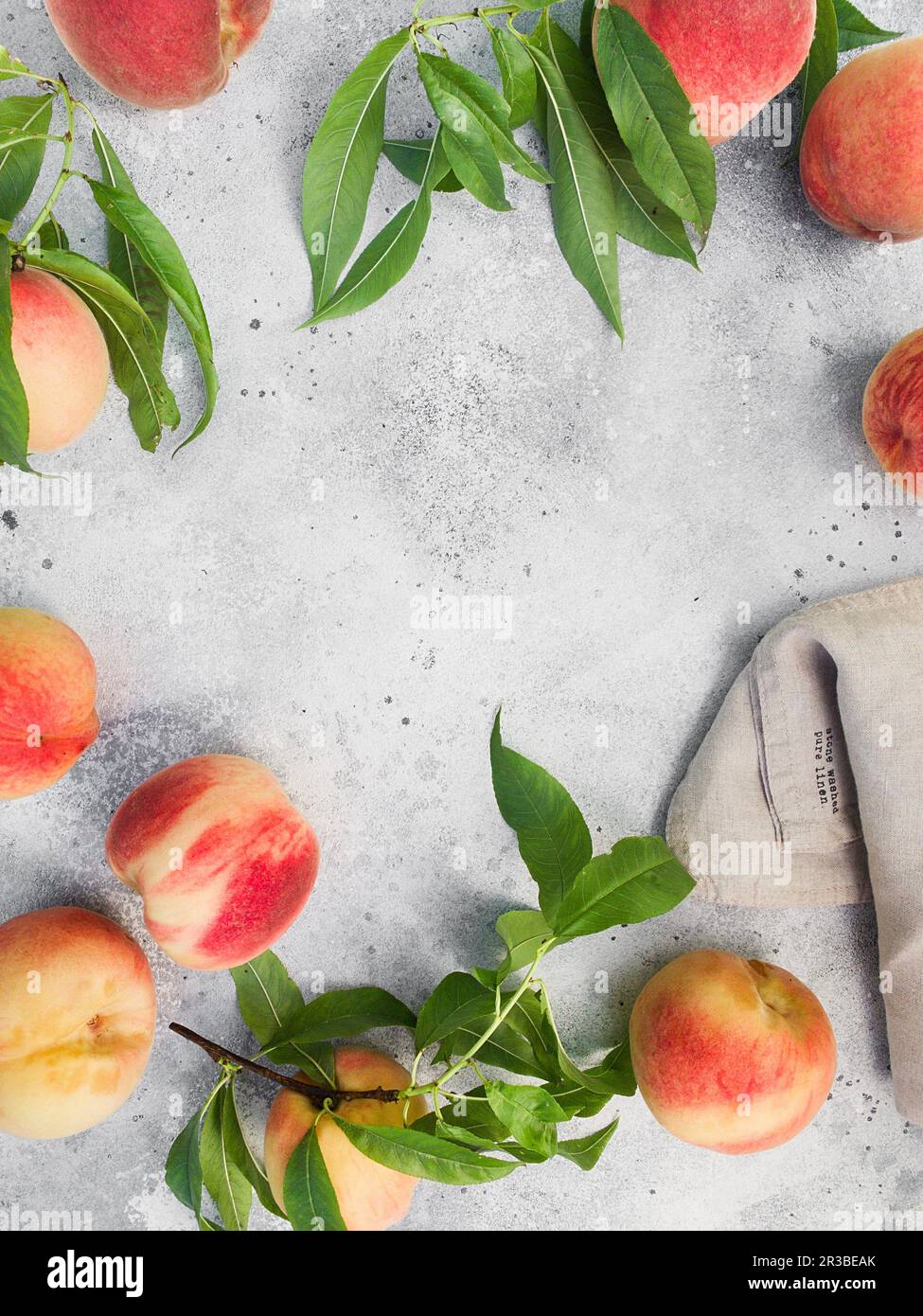 Several ripe juicy peaches on a gray background. Peach fruits on the ...