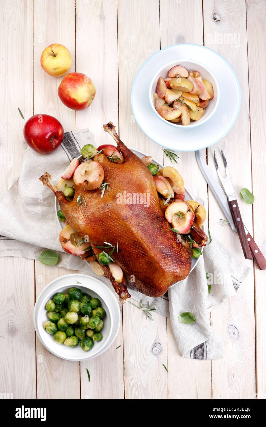 Baked goose with apples and brussels sprout Stock Photo - Alamy