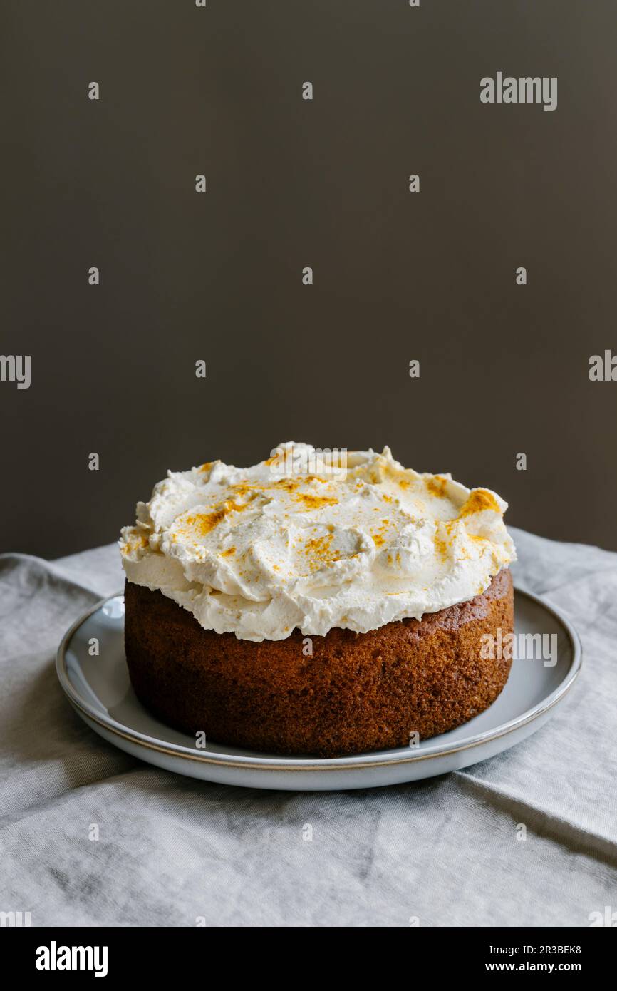 Single-layer turmeric cake with classic cream-cheese frosting Stock ...