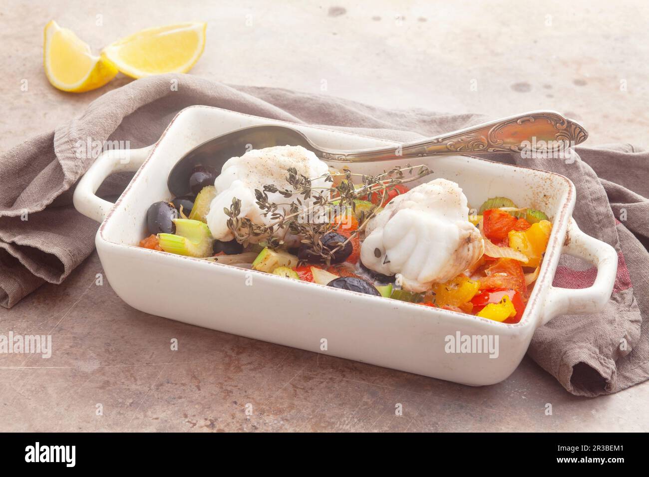Monk fish on a bed oven-roasted vegetables Stock Photo - Alamy