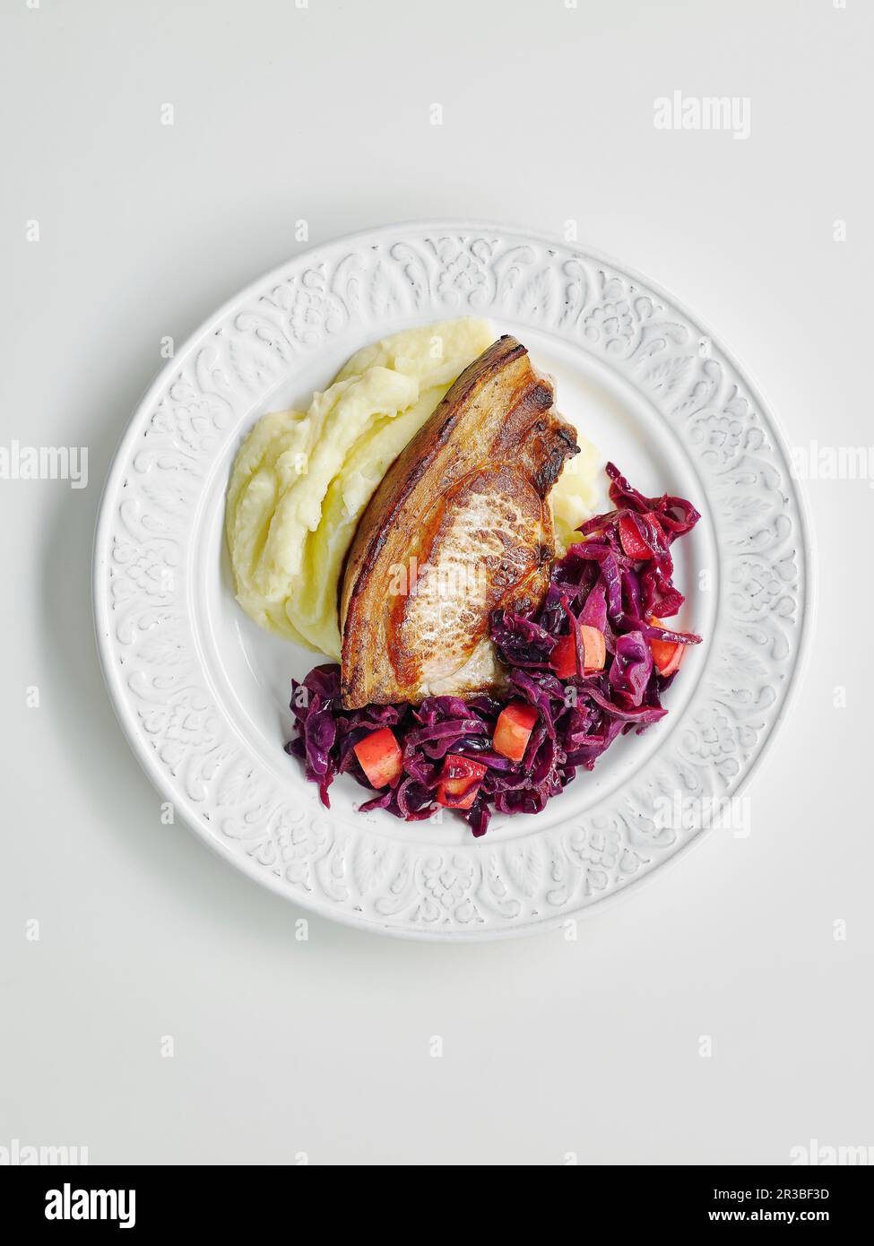 Pork chop with braised red cabbage and mashed potatoes Stock Photo - Alamy