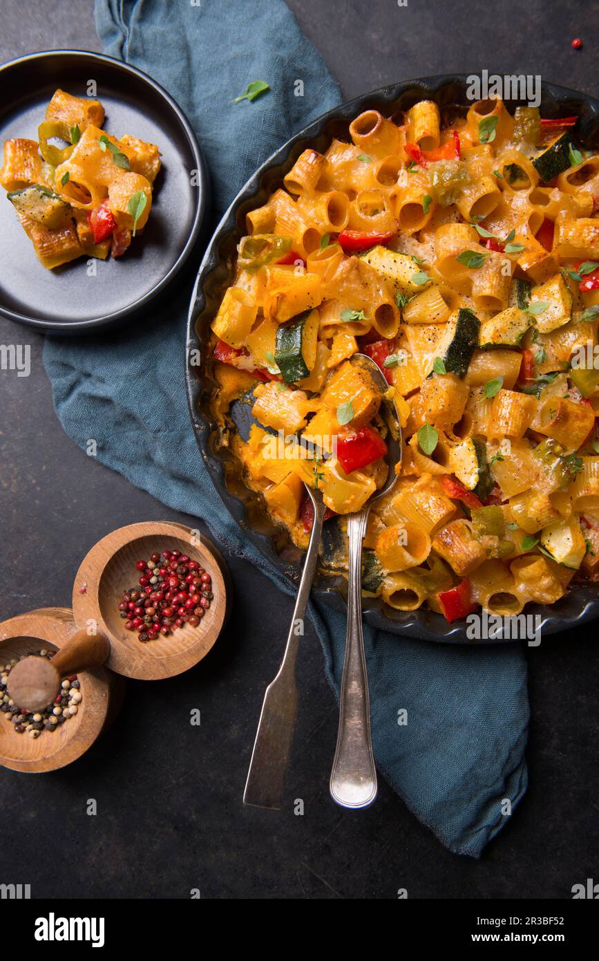 Vegan pasta bake with Hokkaido pumpkin, pepper and courgette Stock ...