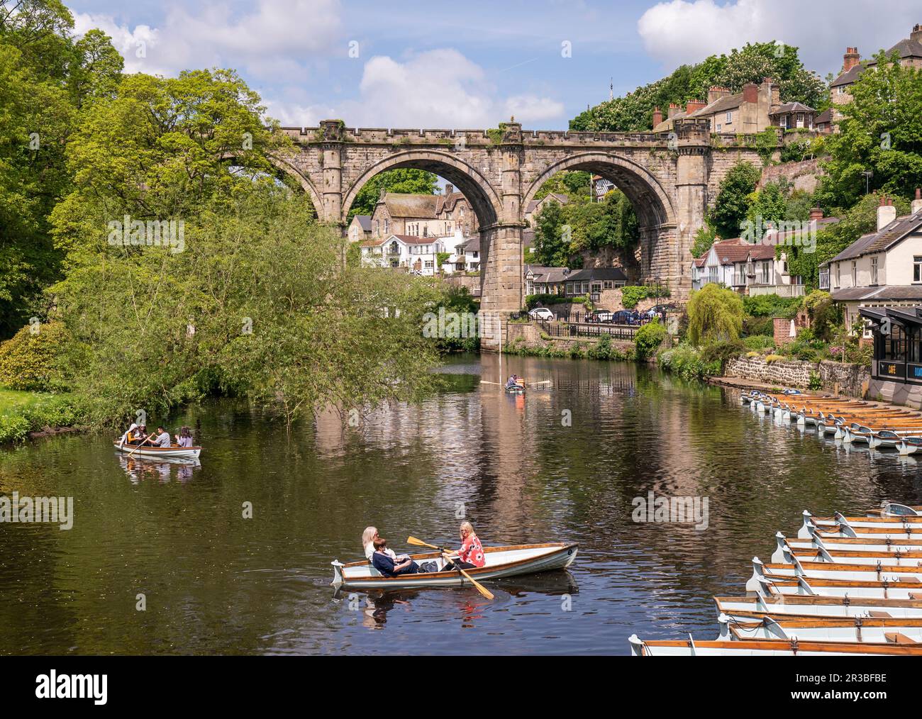 People enjoy the hot weather in rowing boats underneath the ...