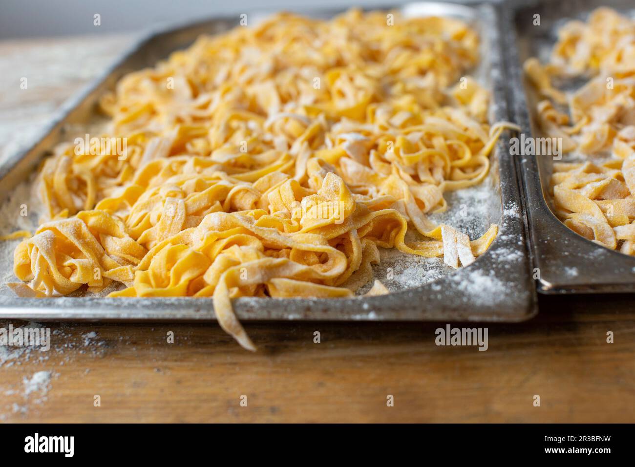 Fresh pasta on oven trays Stock Photo - Alamy