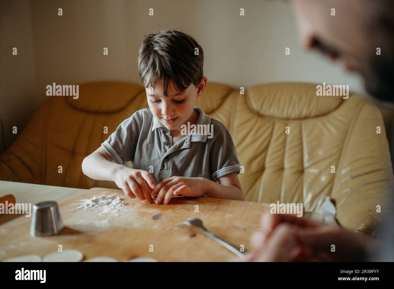 Boy making dumplings with father at home Stock Photo - Alamy