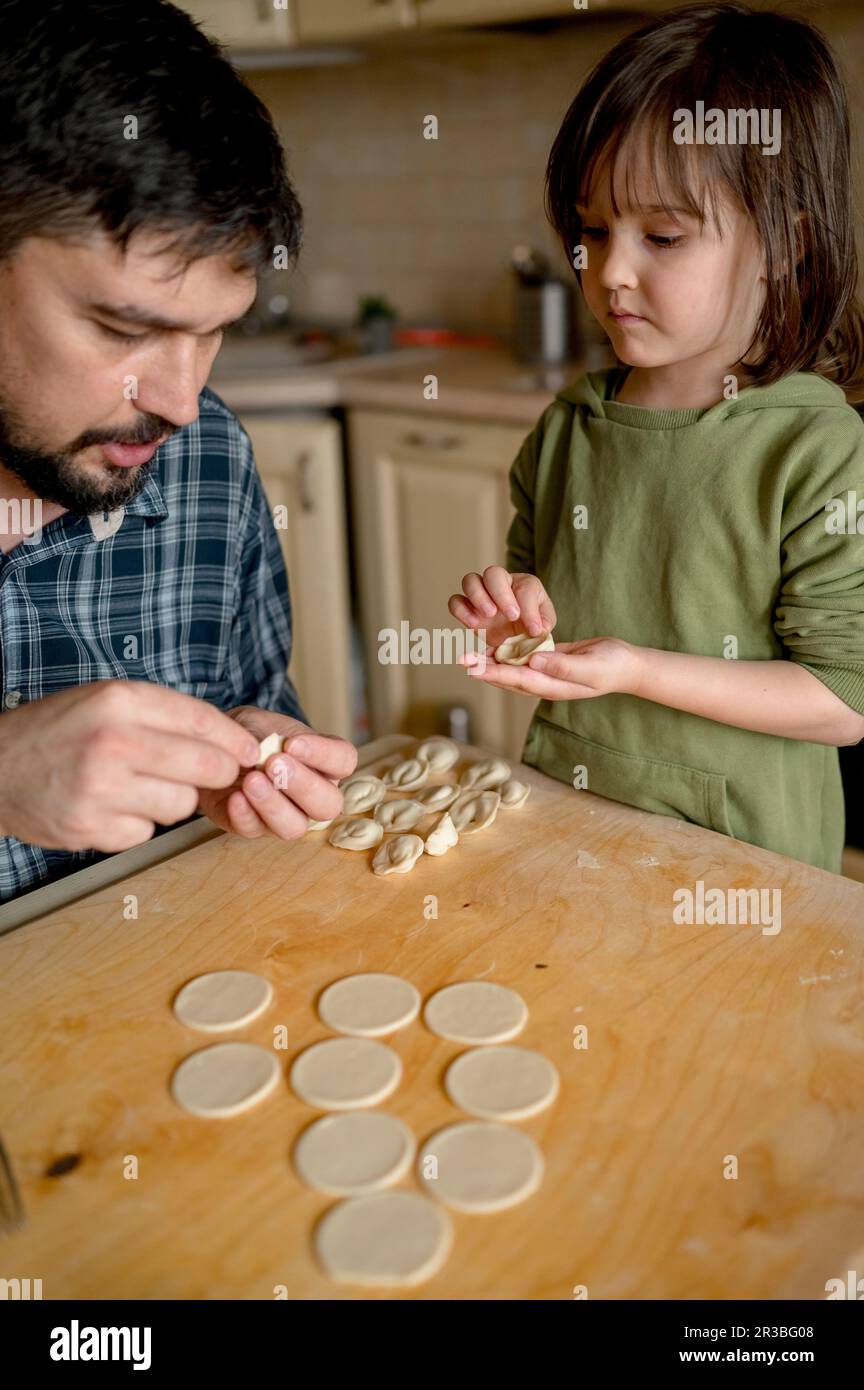 Father teaching son to making dumplings at home Stock Photo - Alamy