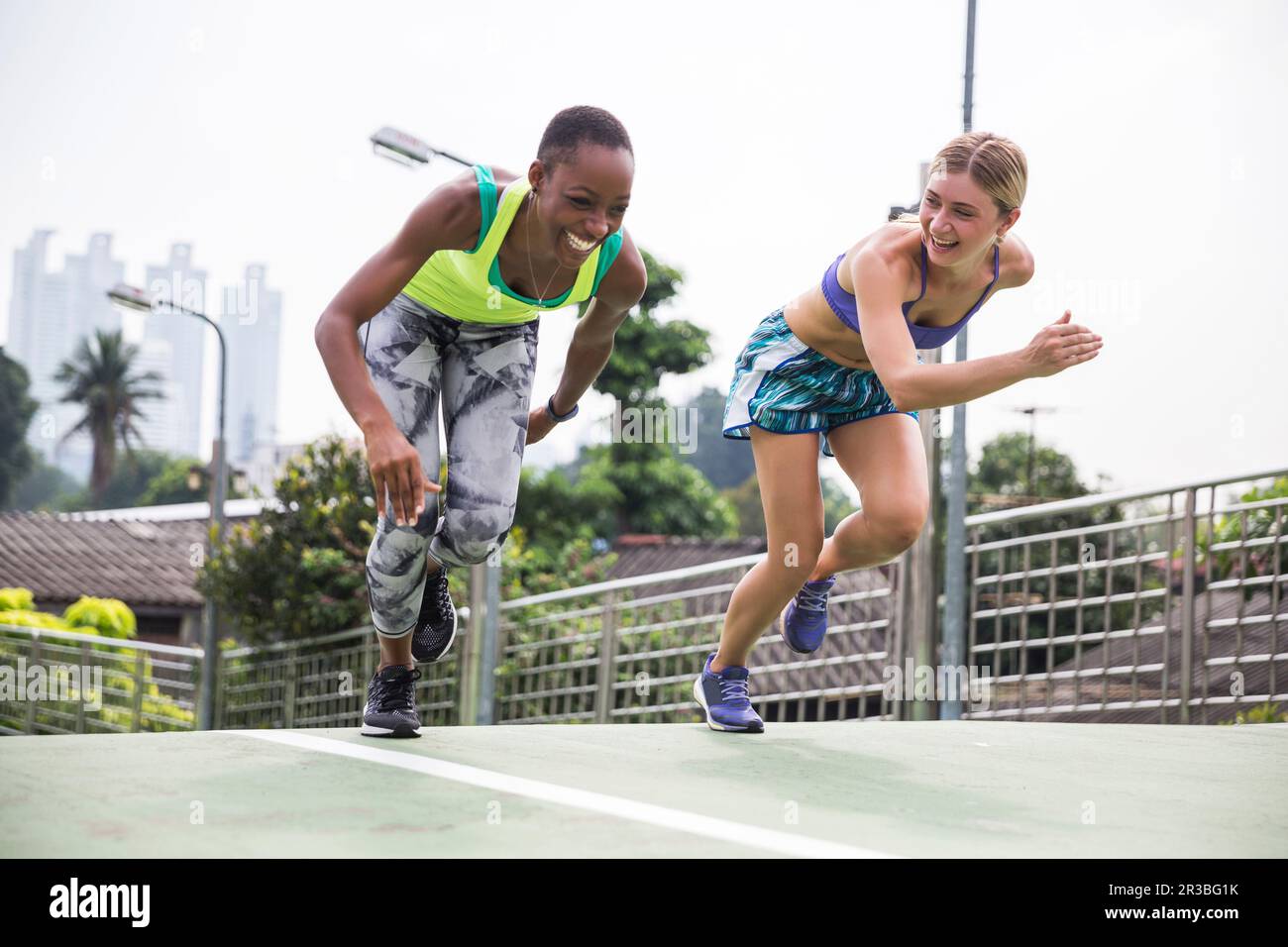 Cheerful multiracial friends running together Stock Photo - Alamy