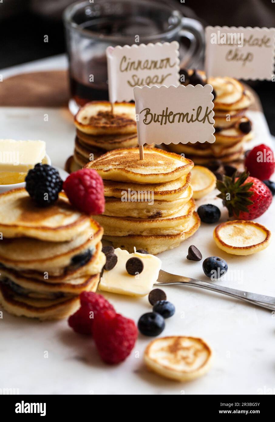Stacks of mini pancakes with signs, with fruit and chocolate chips ...