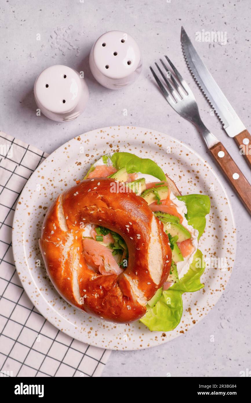 Bagel with cream cheese, lettuce, smoked salmon and avocado Stock Photo ...