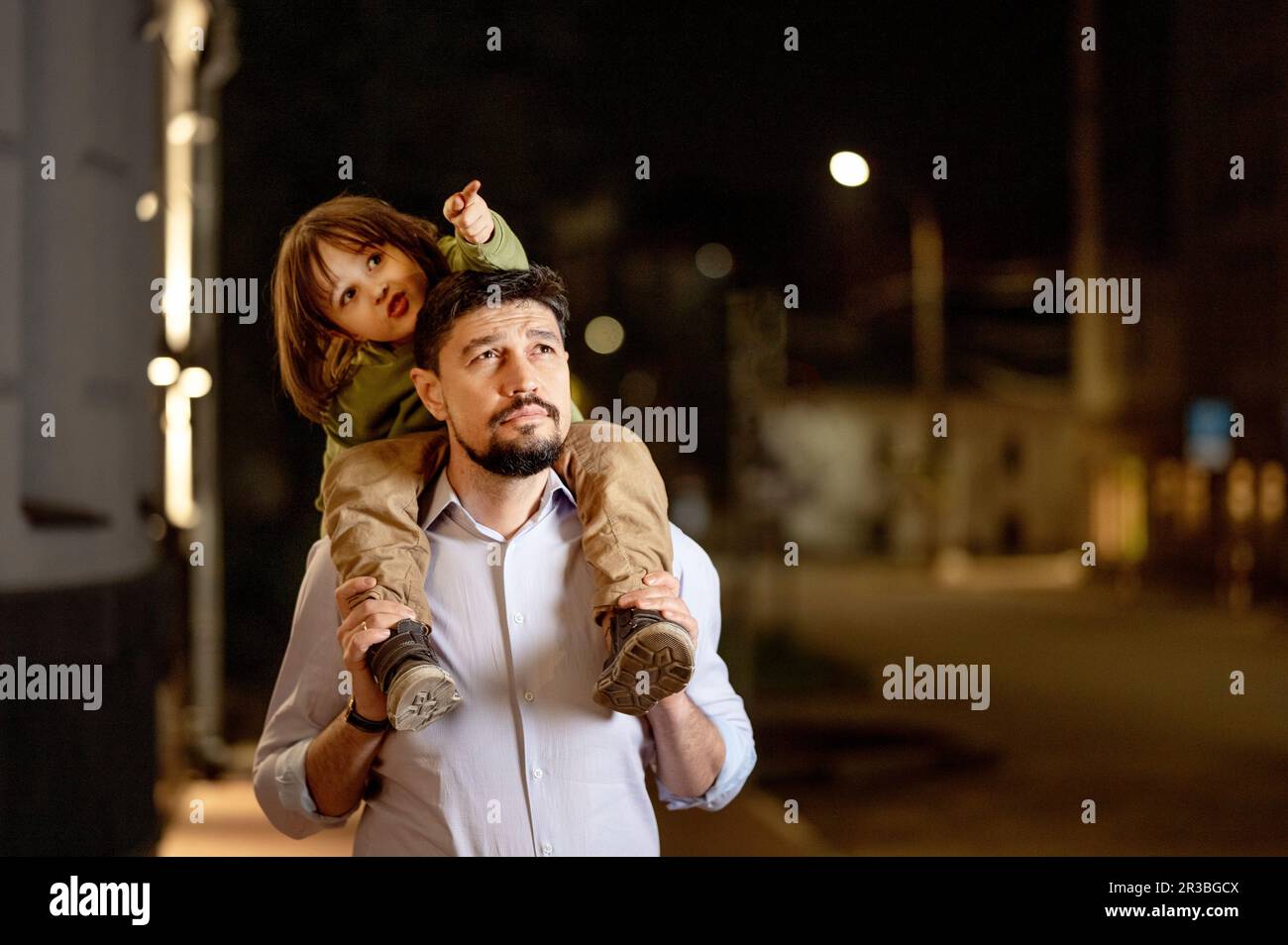 Thoughtful father carrying son on shoulders at night Stock Photo - Alamy