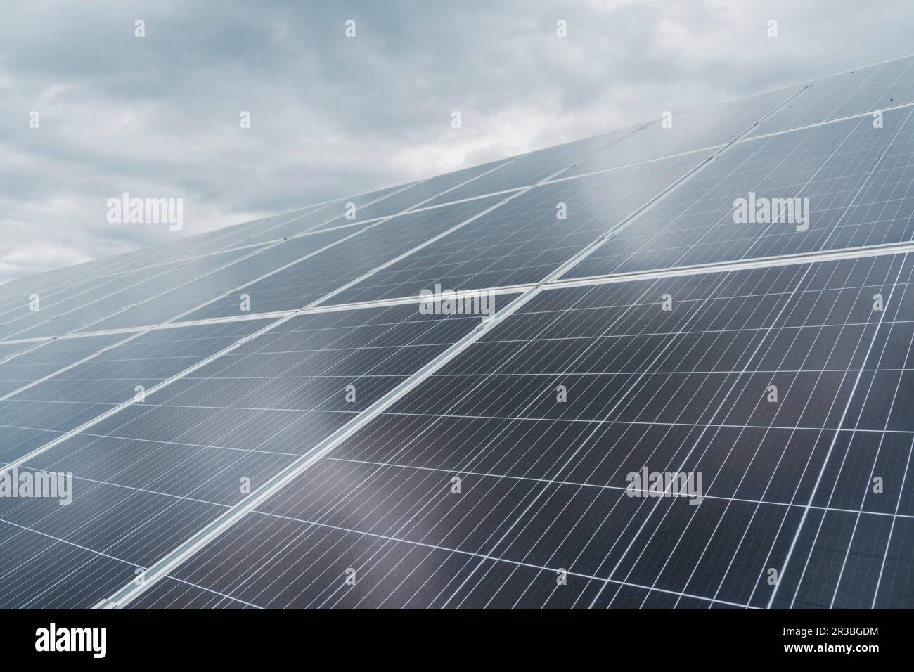 Solar panels under cloudy sky Stock Photo - Alamy