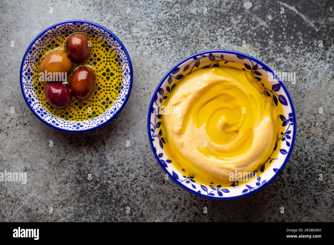 Delicious hummus served with olives in olive oil Stock Photo - Alamy