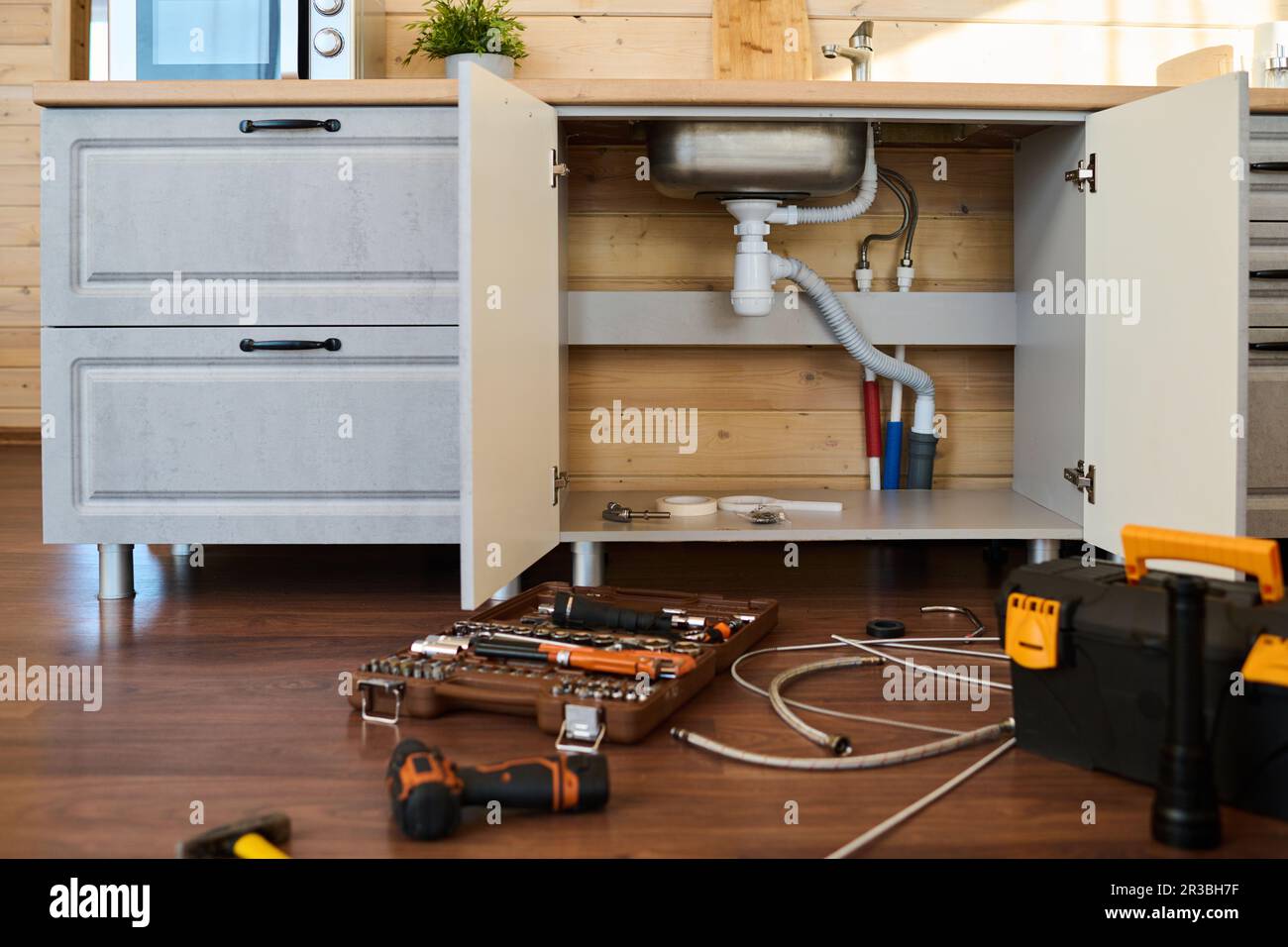 Toolboxes with handtools and other equipment on the floor by open ...