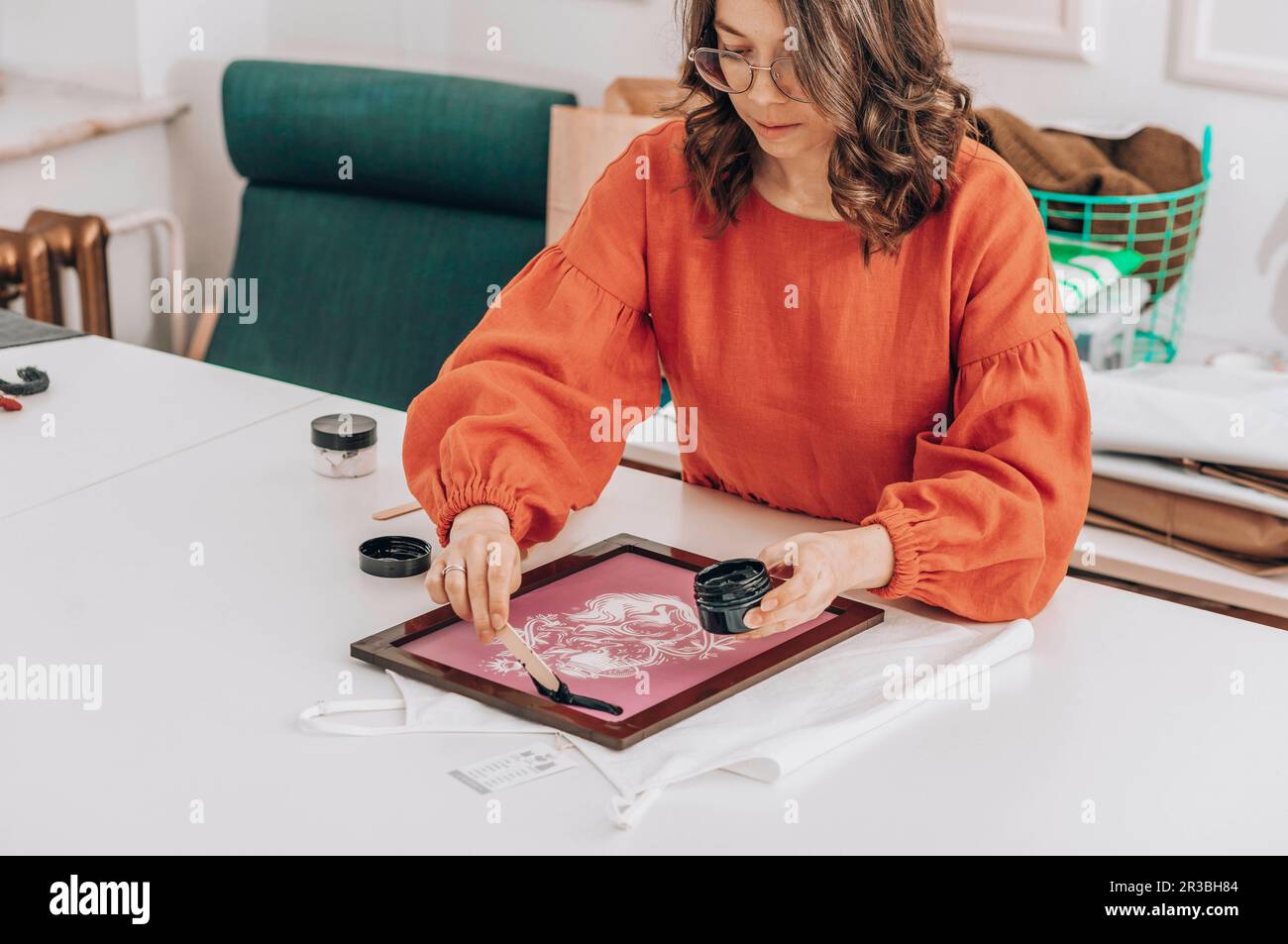 Fashion designer applying ink on fabric at workshop Stock Photo - Alamy
