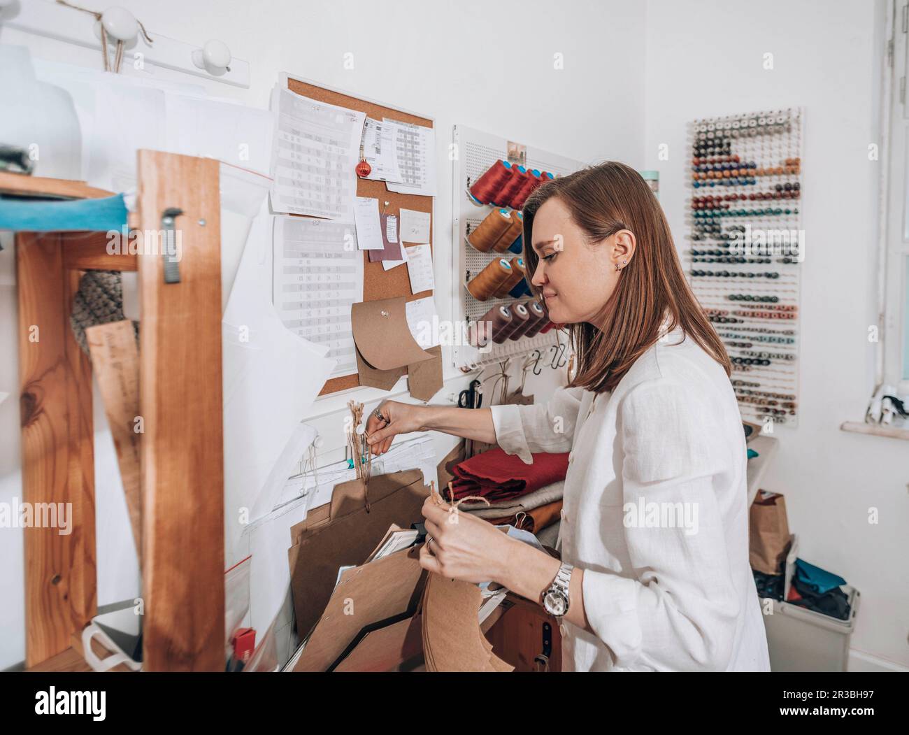 Professional designer examining samples hi-res stock photography and ...