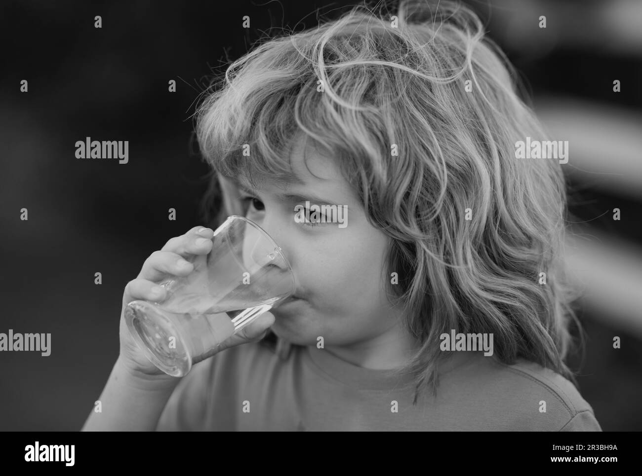 Child drinking water outdoor in park. Kid drinking. Close up portrait ...