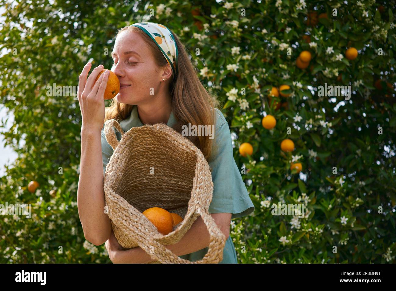 Woman smelling orange fruit hi-res stock photography and images - Alamy