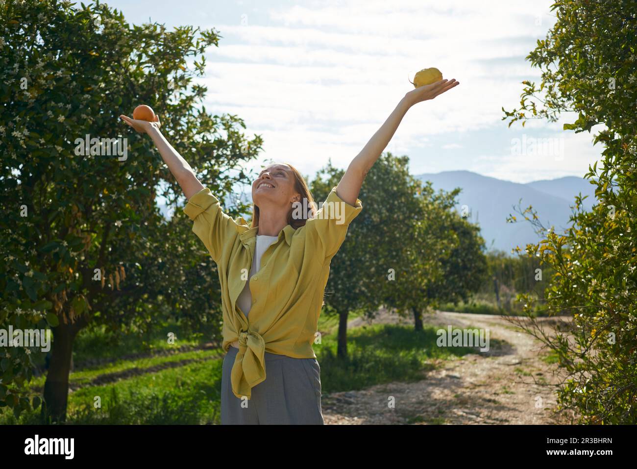 Woman holding citrus fruits in hand at orchard Stock Photo - Alamy