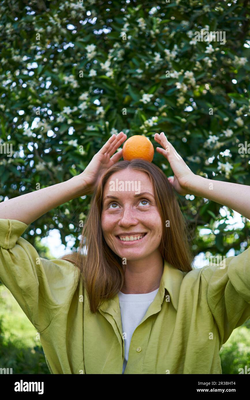 Woman in orange garden hi-res stock photography and images - Alamy