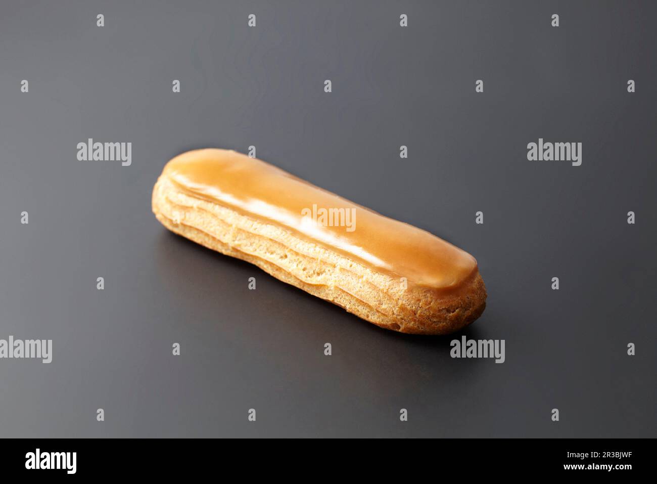 A salted caramel eclair Stock Photo - Alamy