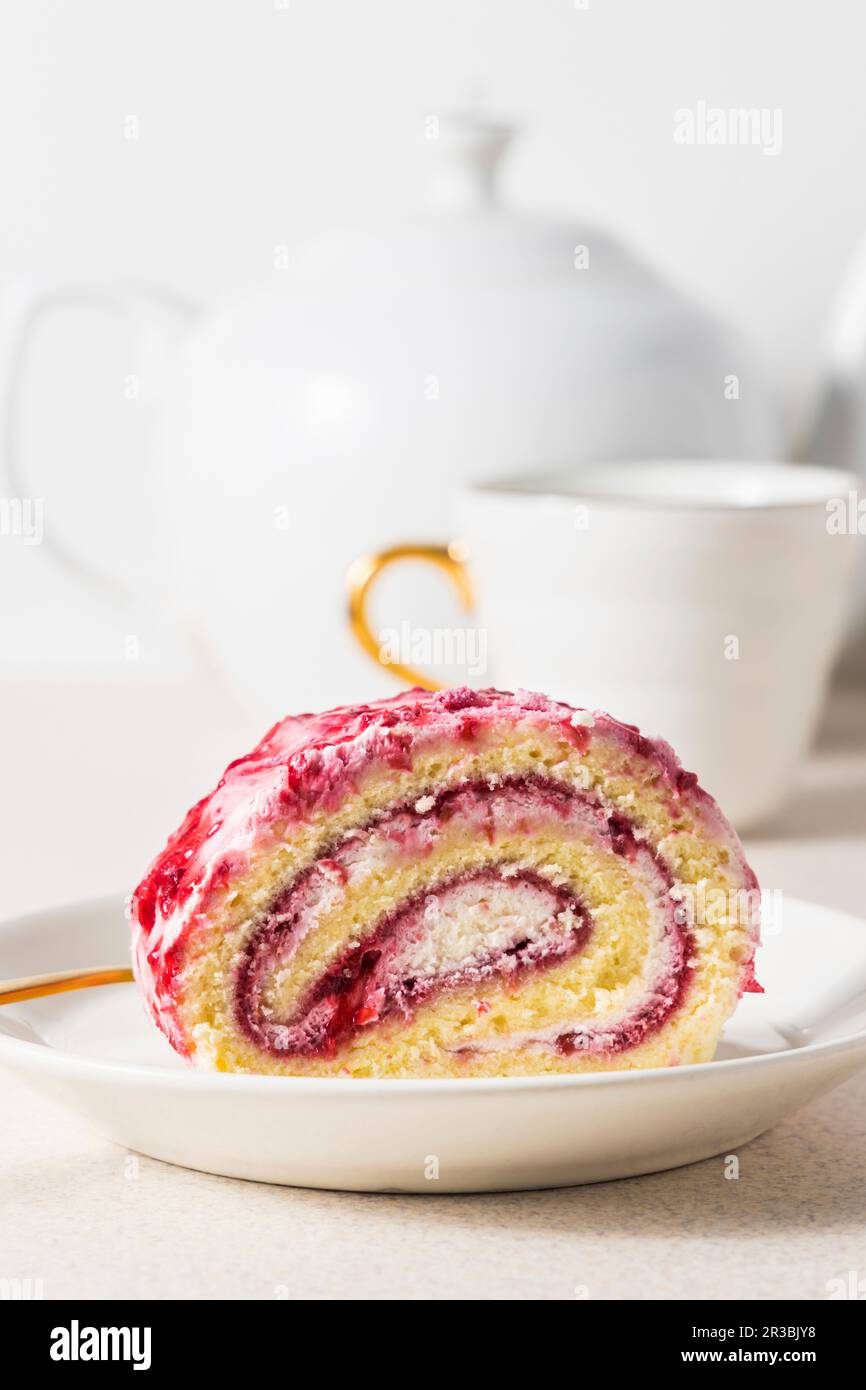 Vanilla raspberry swiss roll cake Stock Photo - Alamy