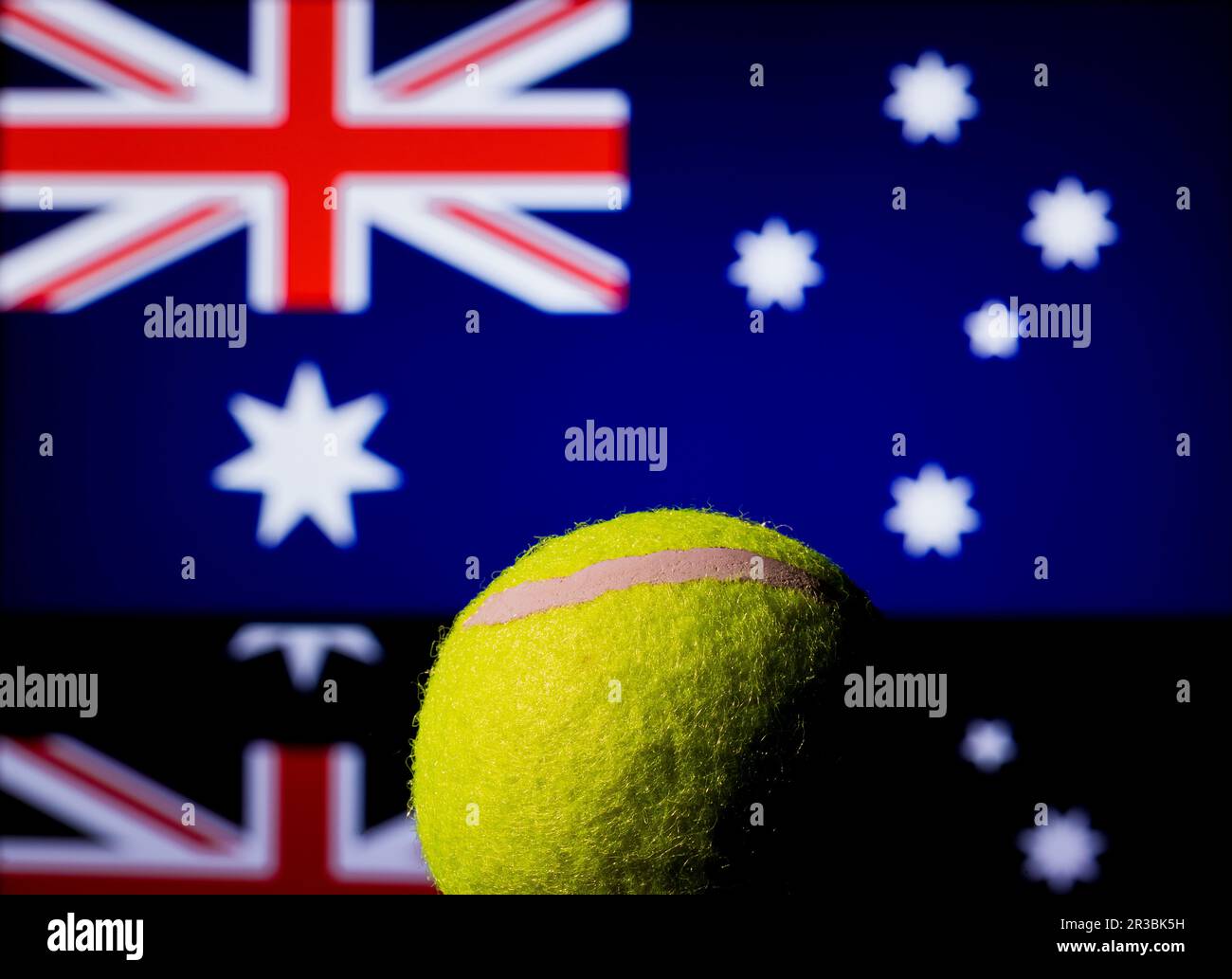 Yellow Tennis Ball on black mirror with Australian Flag in the ...