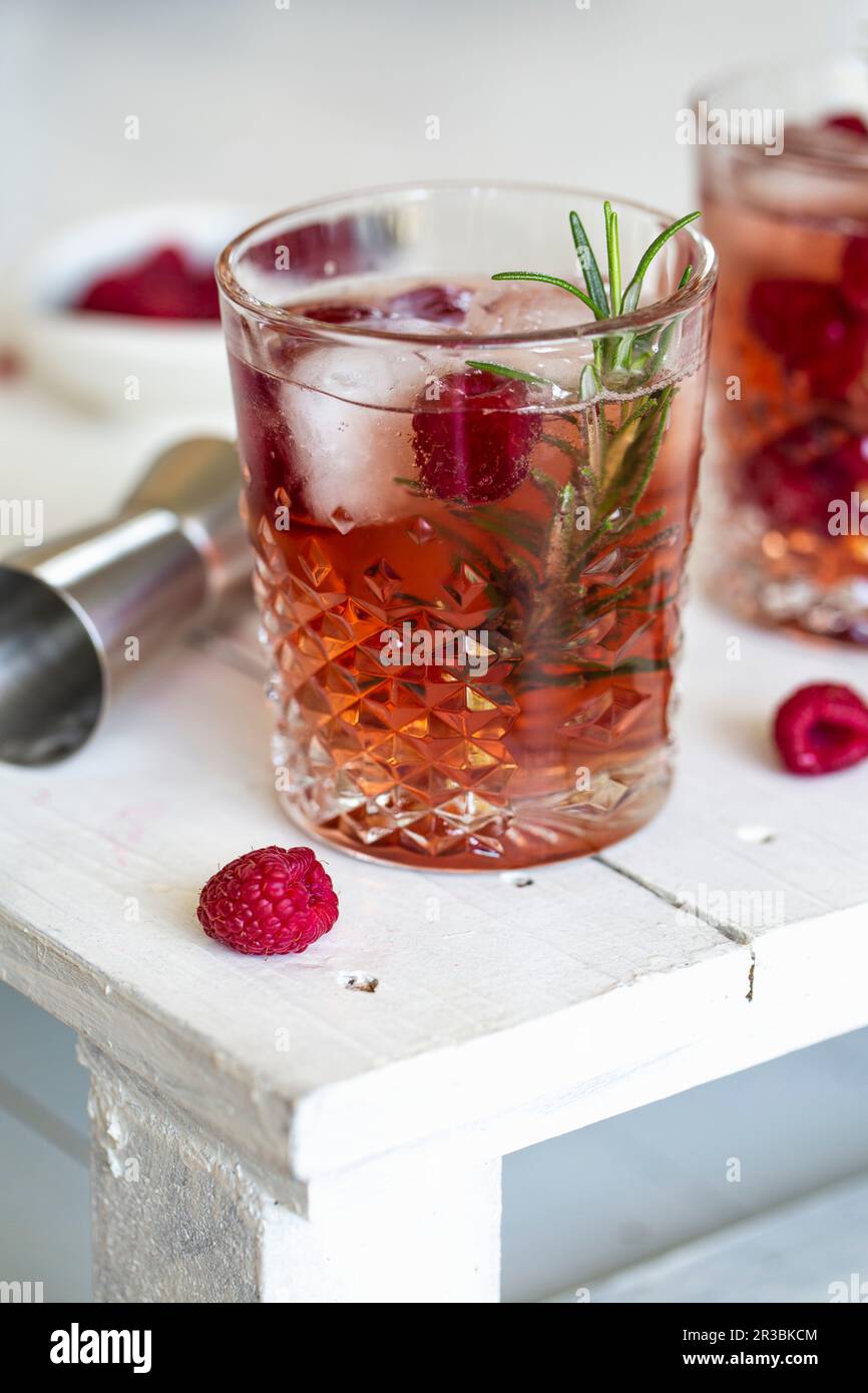 Gin & Tonic with raspberries and rosemary Stock Photo - Alamy