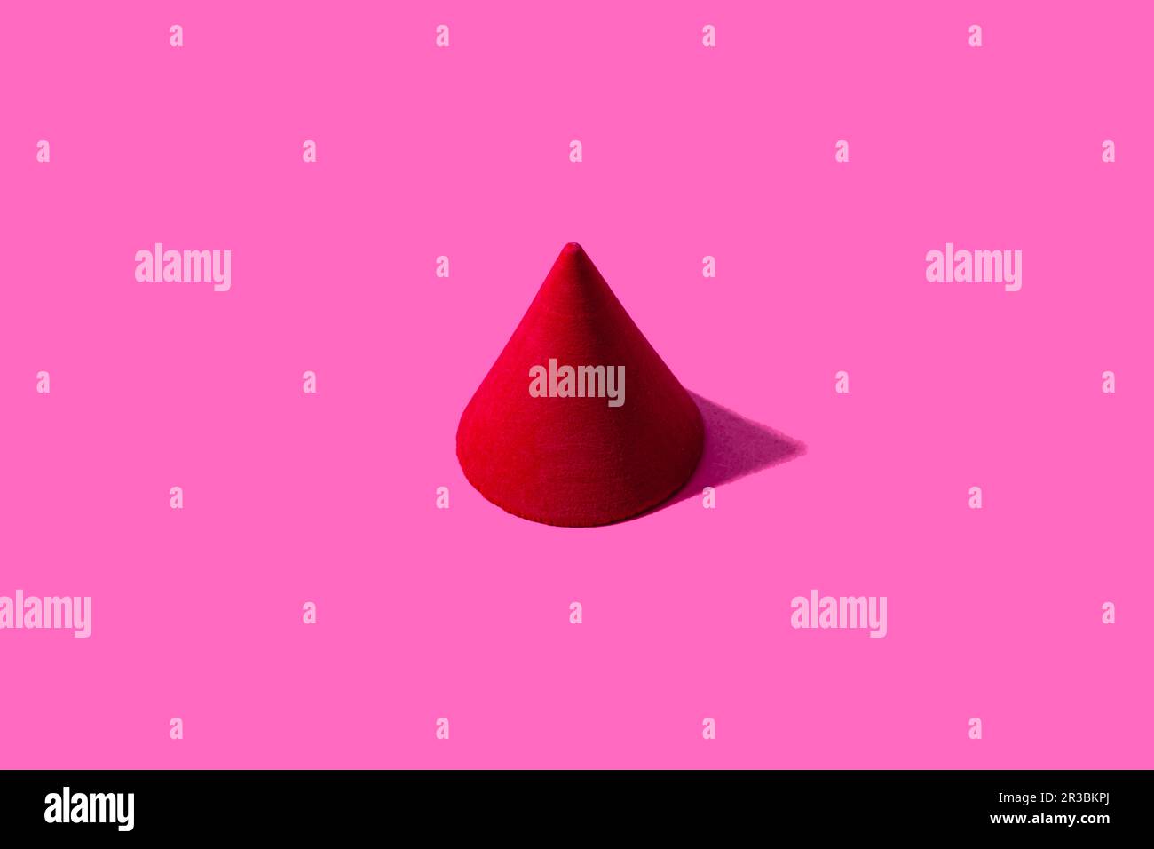3D render of red cone against pink background Stock Photo - Alamy