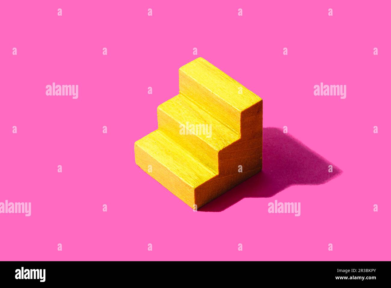 3D render of wooden steps block against pink background Stock Photo - Alamy