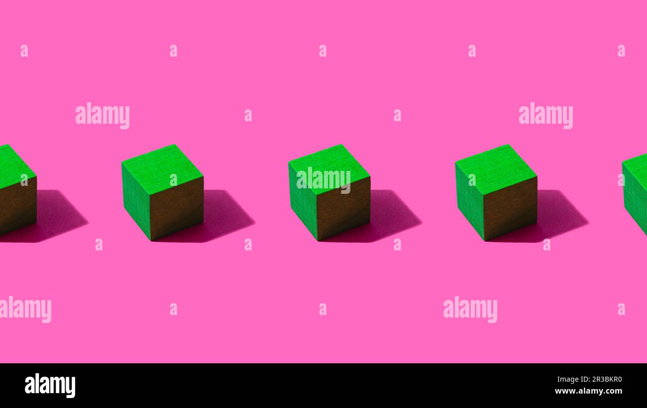 3D render of row of green cubes against pink background Stock Photo - Alamy