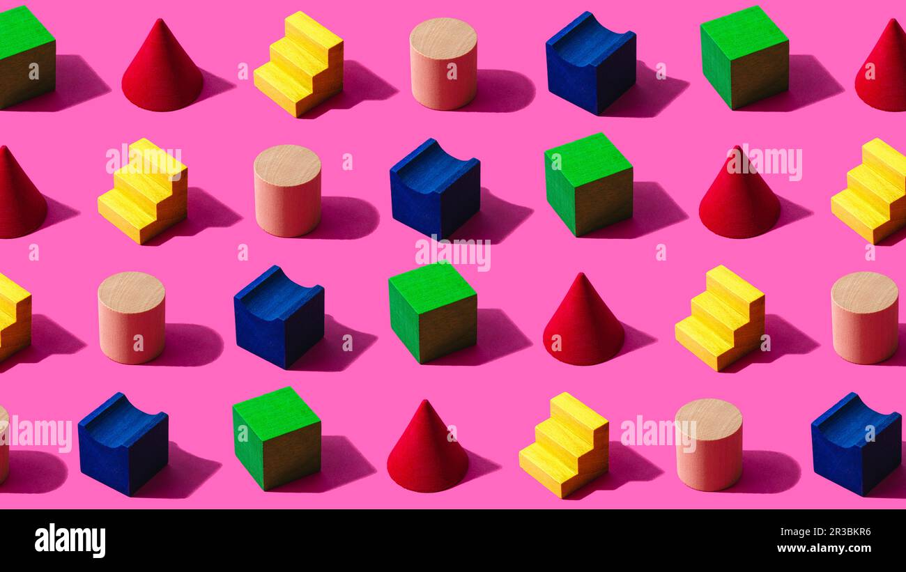 3D pattern of colorful toy blocks flat laid against pink background ...