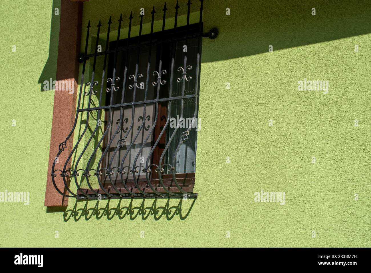Cast Iron window grating with green wall Stock Photo - Alamy