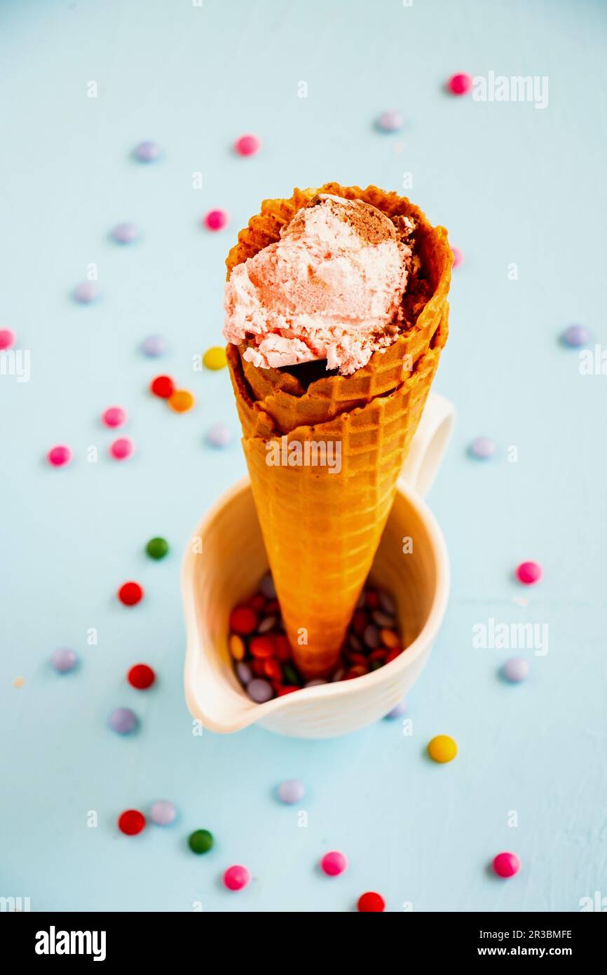 Ice cream in waffle cone with smarties Stock Photo - Alamy