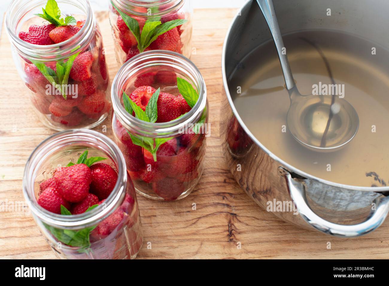 Fresh strawberries in jars with mint, ready for syrup Stock Photo - Alamy