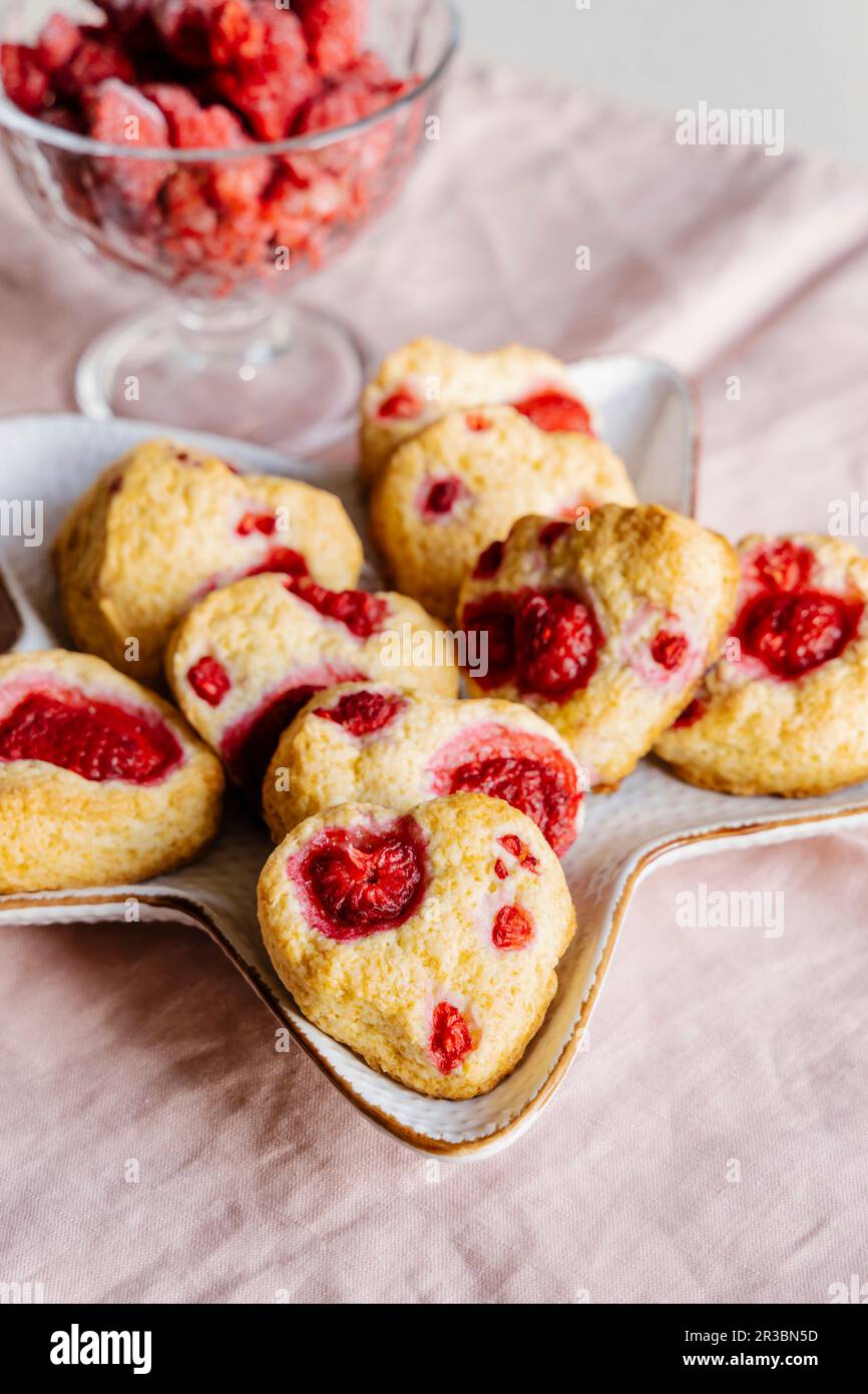 Heart-shaped vanilla shortcake biscuits with raspberries Stock Photo ...