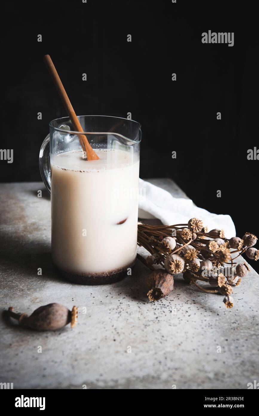 Vegan poppy milk in glass jug Stock Photo - Alamy