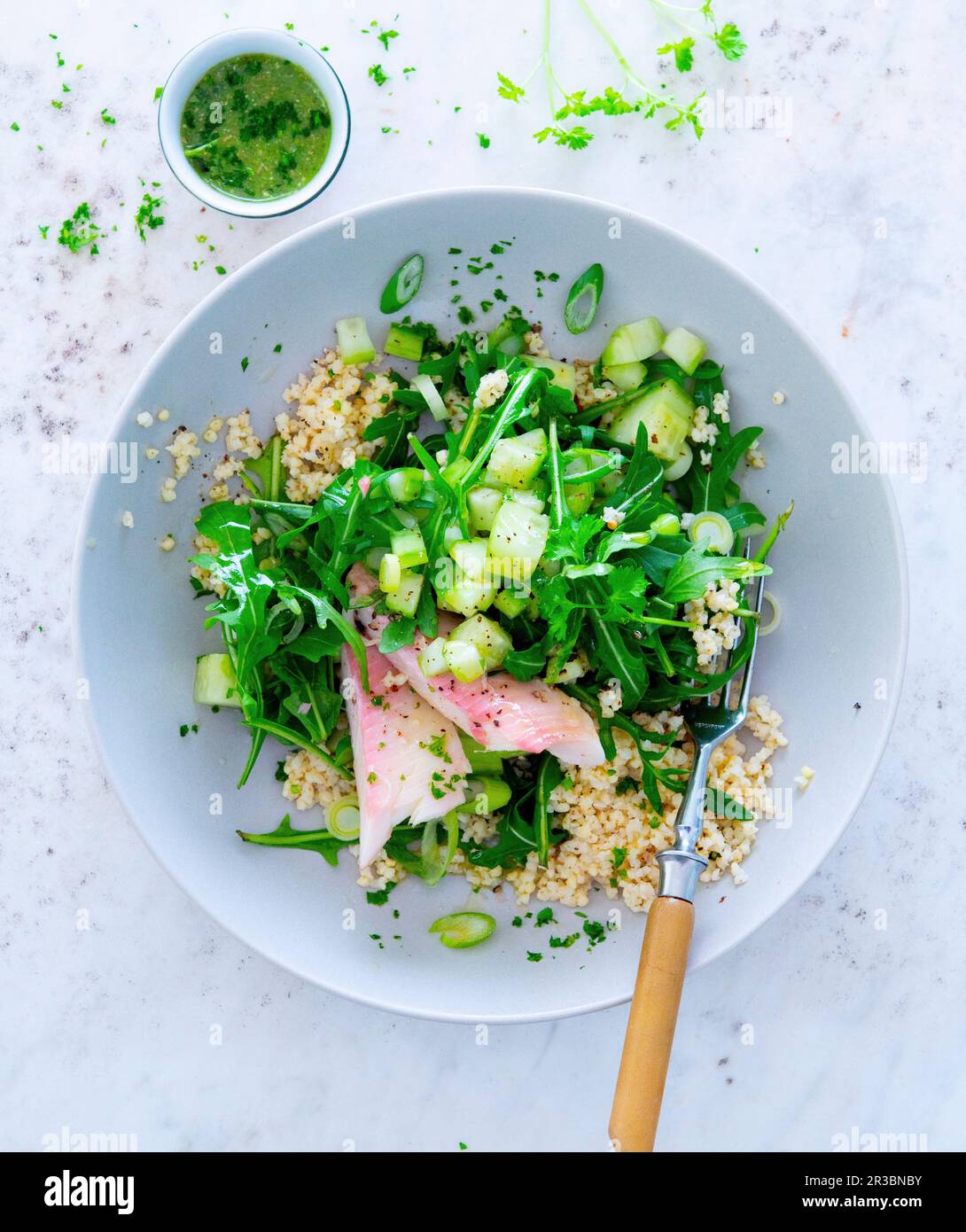Millet salad with smoked trout, rocket and cucumber Stock Photo - Alamy