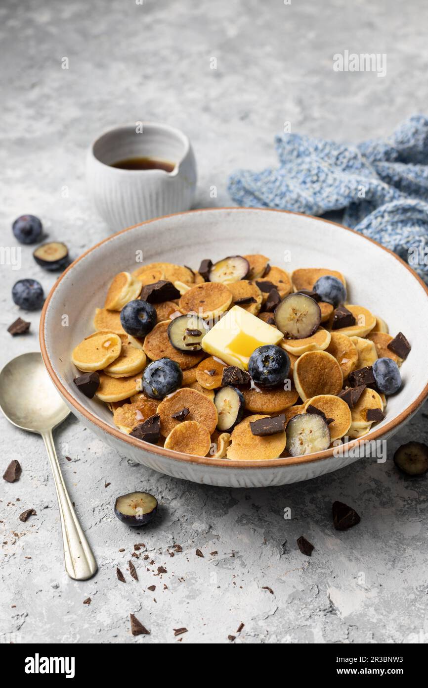 Pancake cereal with blueberries, chocolate, butter and maple syrup ...