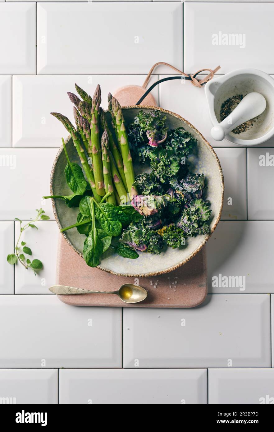Mini asparagus, Flower Sprouts and spinach in a ceramic bowl Stock ...