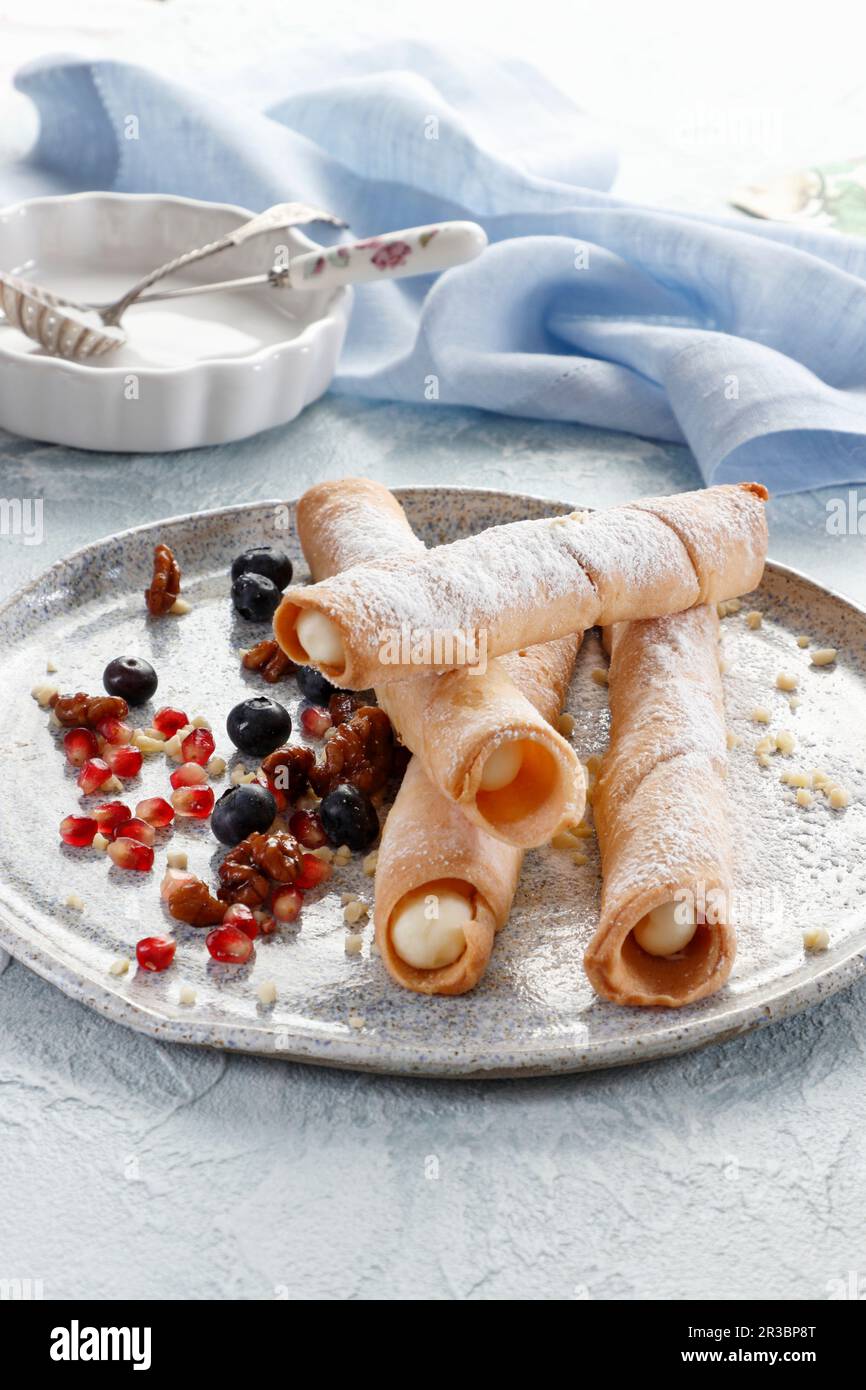 Sponge cake tubes stuffed with vanilla cream Stock Photo - Alamy