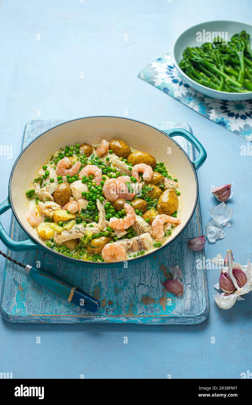 One pot dish of fish and prawns with new potatoes and creamy garlic ...