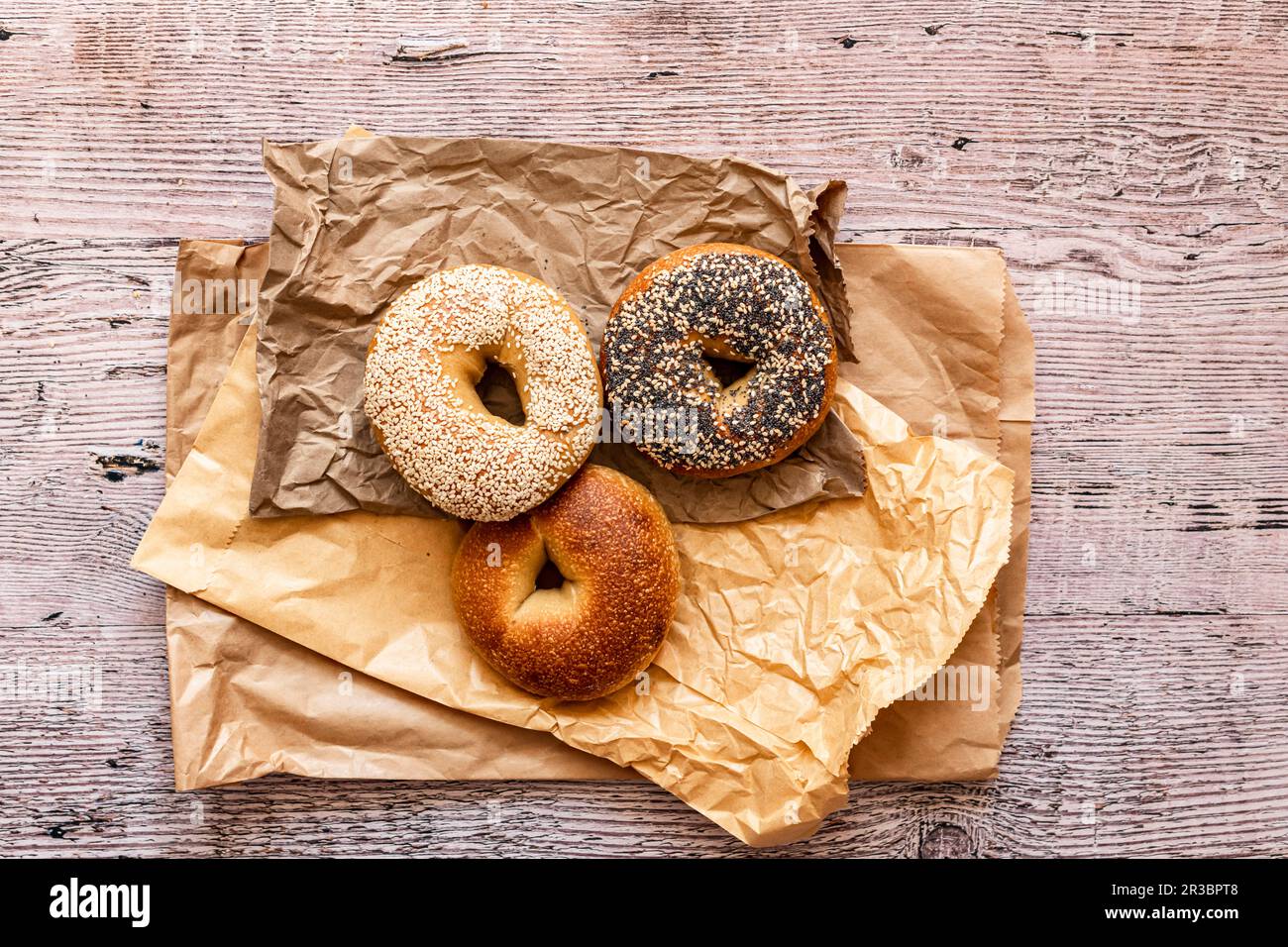 Selection of bagels on brown paper bags Stock Photo - Alamy