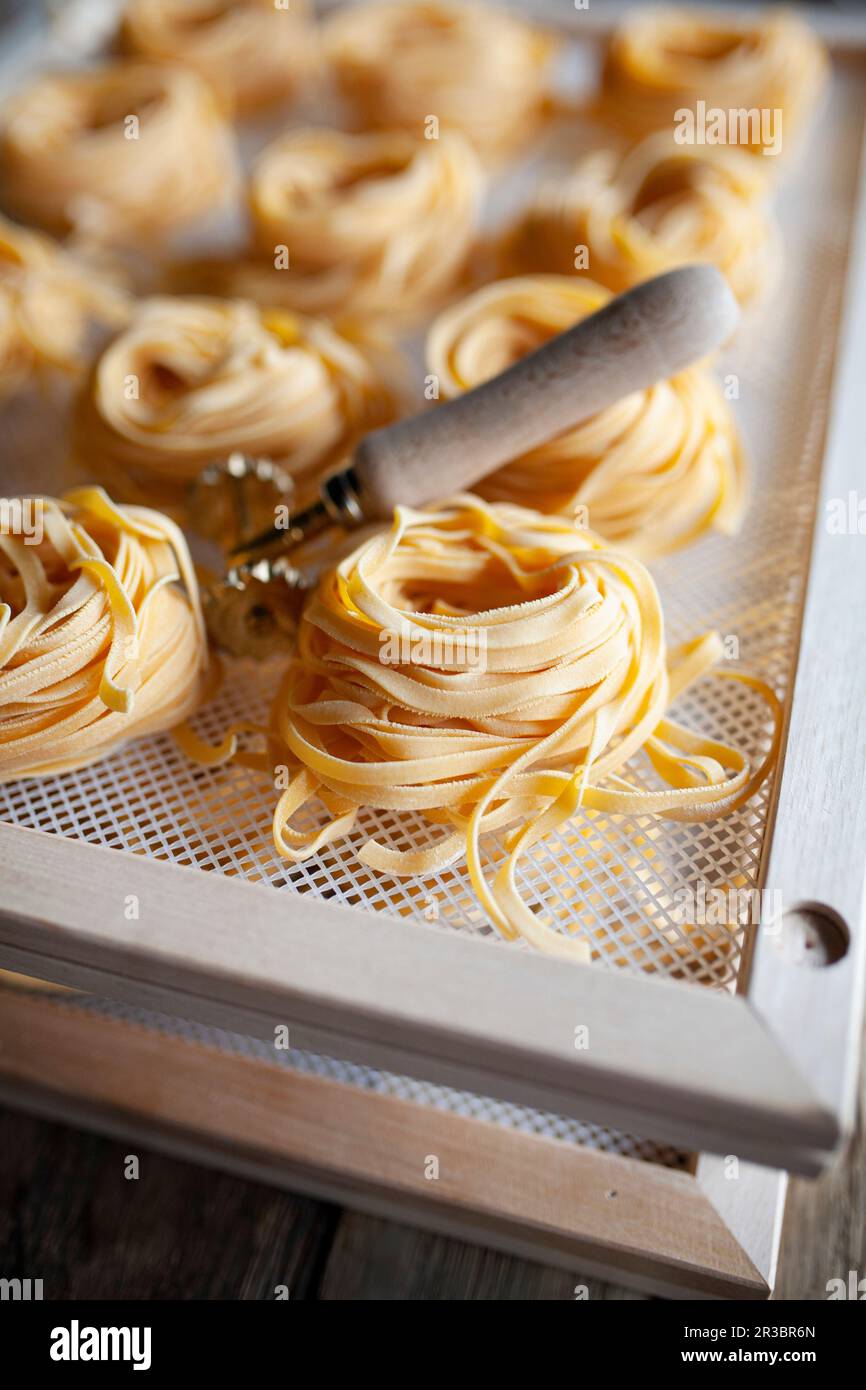 Fresh linguine in nests on drying racks Stock Photo - Alamy