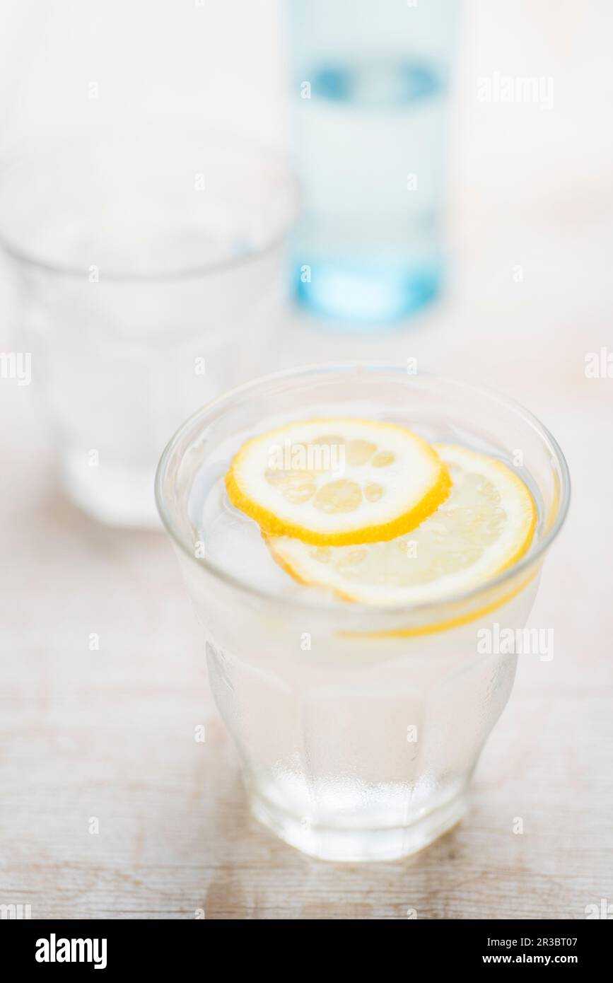 Fresh water in a glass with ice cubes and lemon slices Stock Photo - Alamy