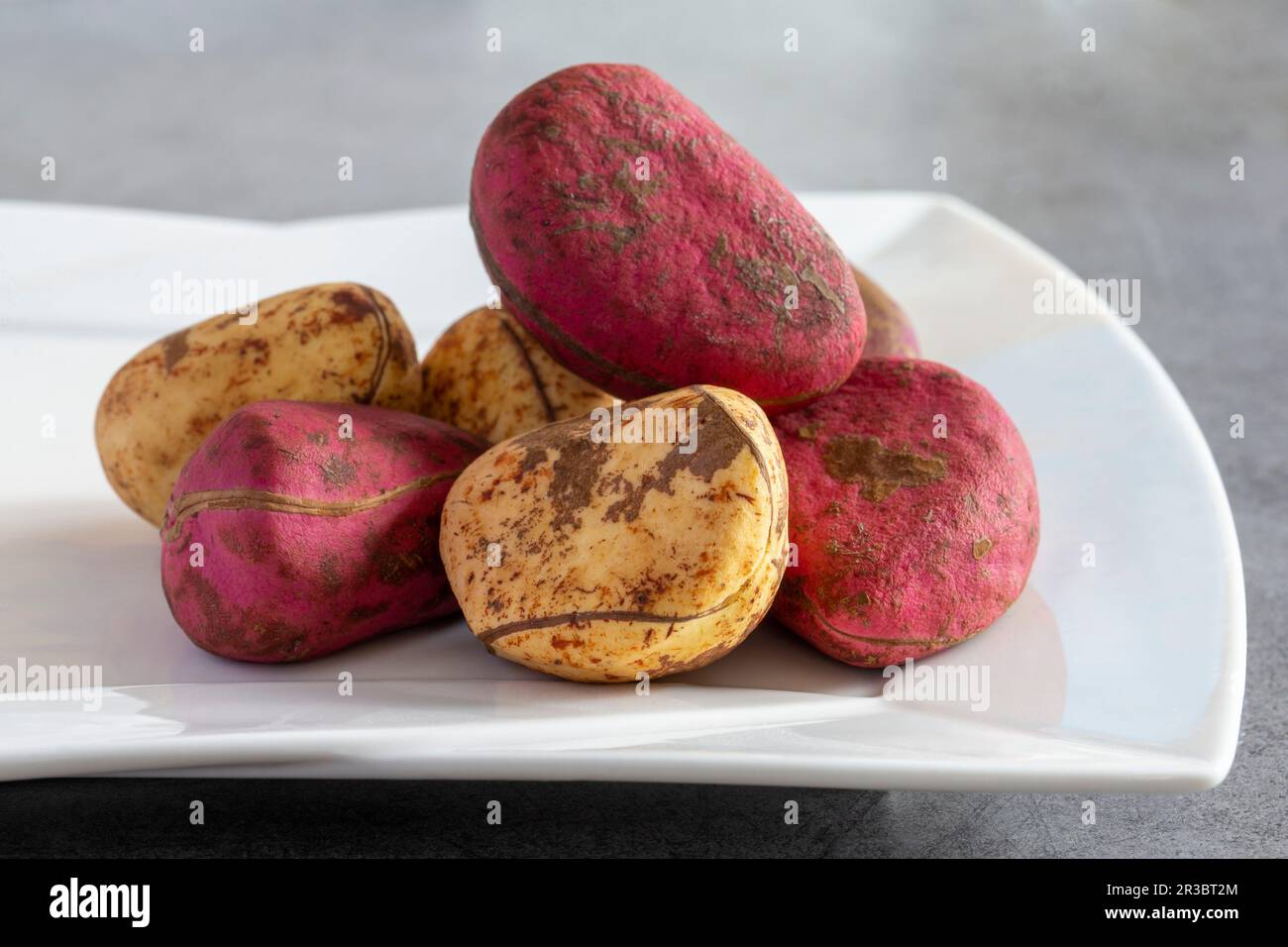 Cola nuts in yellow and red Stock Photo - Alamy