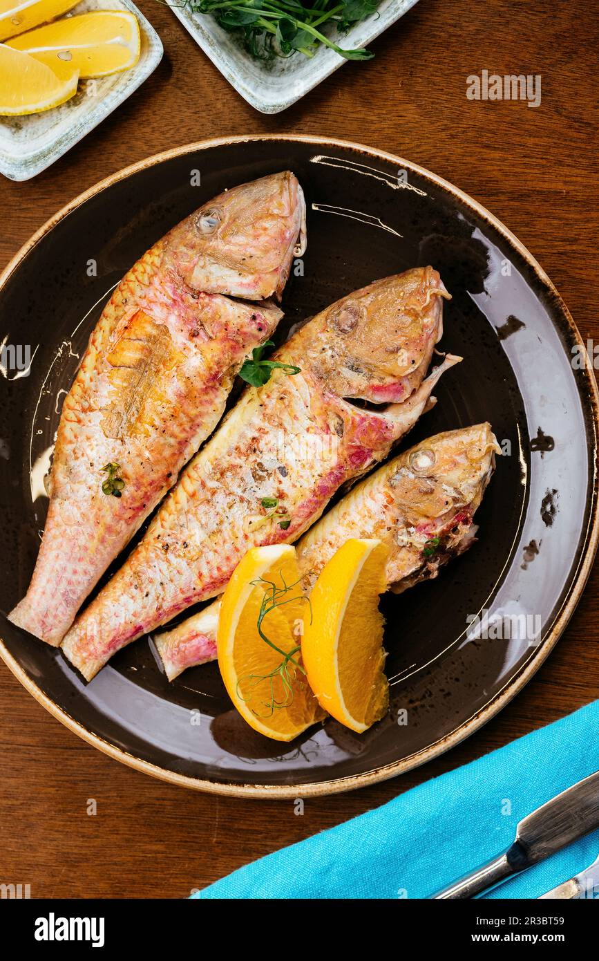 Grilled fish with herbs and lemon Stock Photo - Alamy