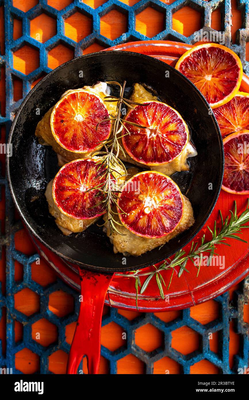 Chicken with blood oranges and rosemary Stock Photo - Alamy
