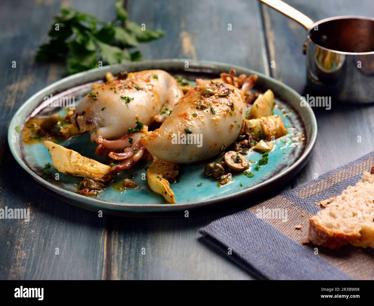 Stuffed calamari with artichokes and olives Stock Photo - Alamy