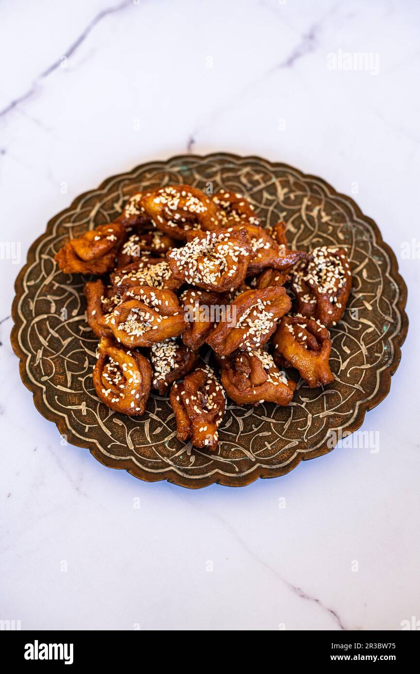 Chebakia - Moroccan pastry made of strips of dough rolled, deep-fried ...